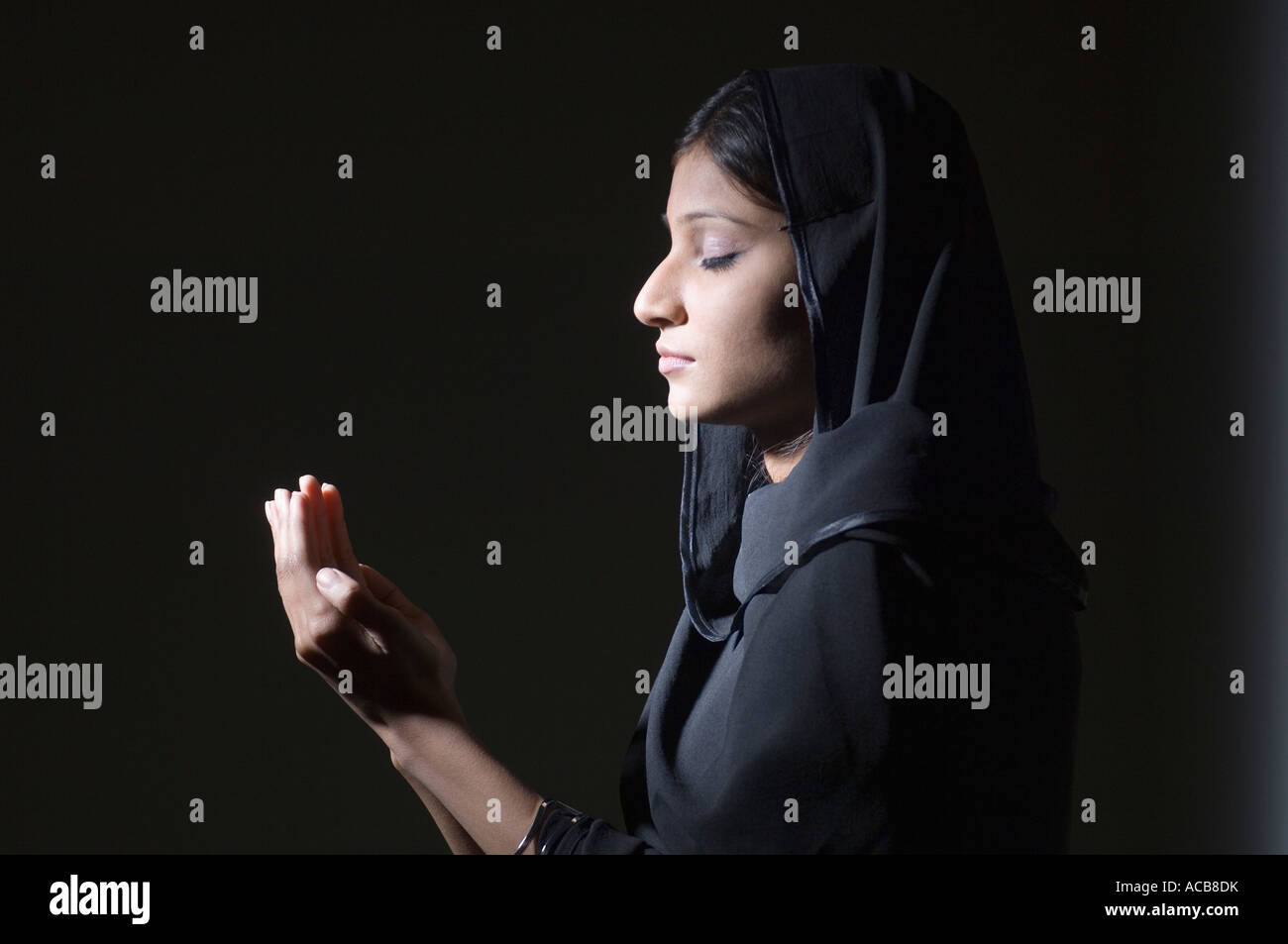 Side profile of a young woman praying Stock Photo - Alamy
