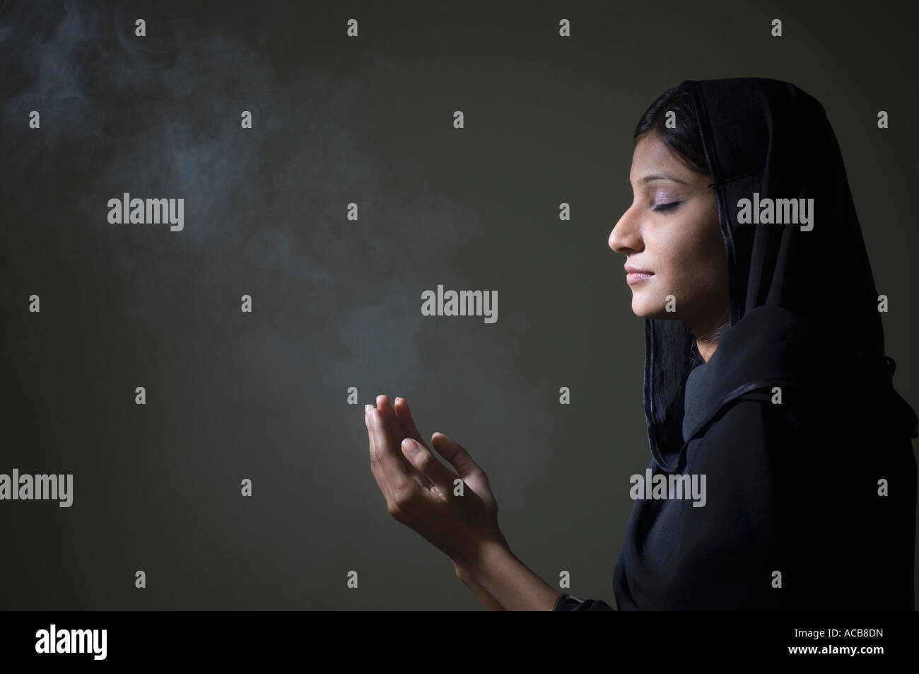 Side profile of a young woman praying Stock Photo - Alamy