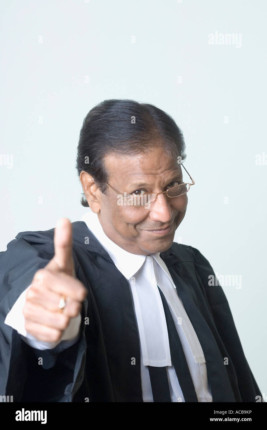 Portrait of a male lawyer showing thumbs up Stock Photo - Alamy