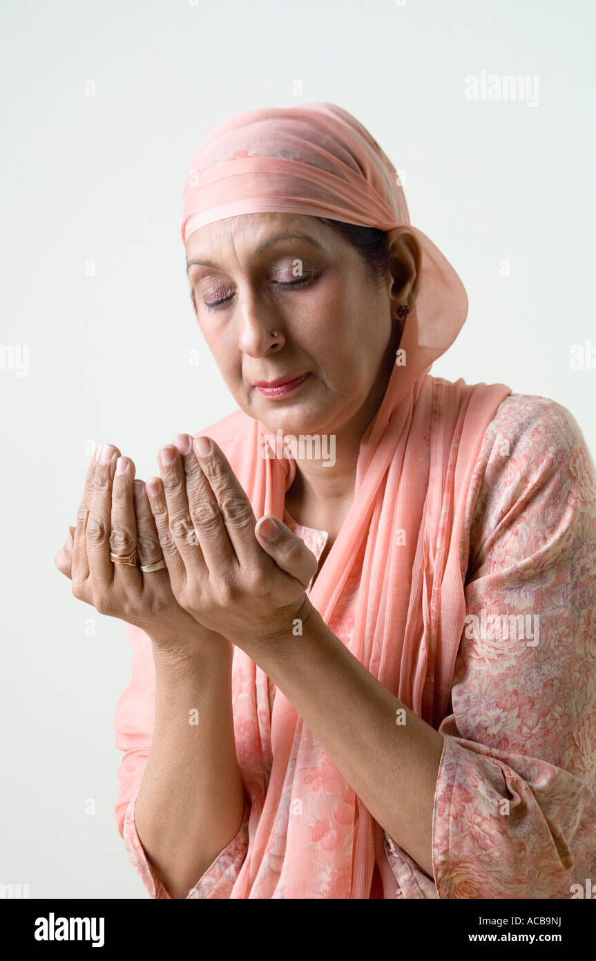 Close-up of a mature woman praying Stock Photo - Alamy
