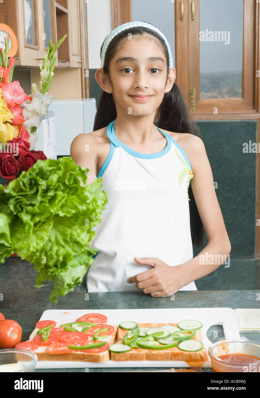 Portrait of a girl making a sandwich Stock Photo - Alamy