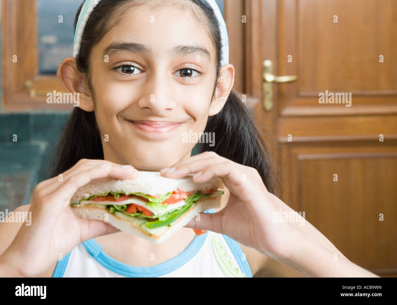 Portrait of a girl eating a sandwich Stock Photo - Alamy