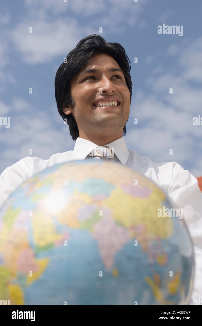 Low angle view of a businessman with a globe Stock Photo - Alamy