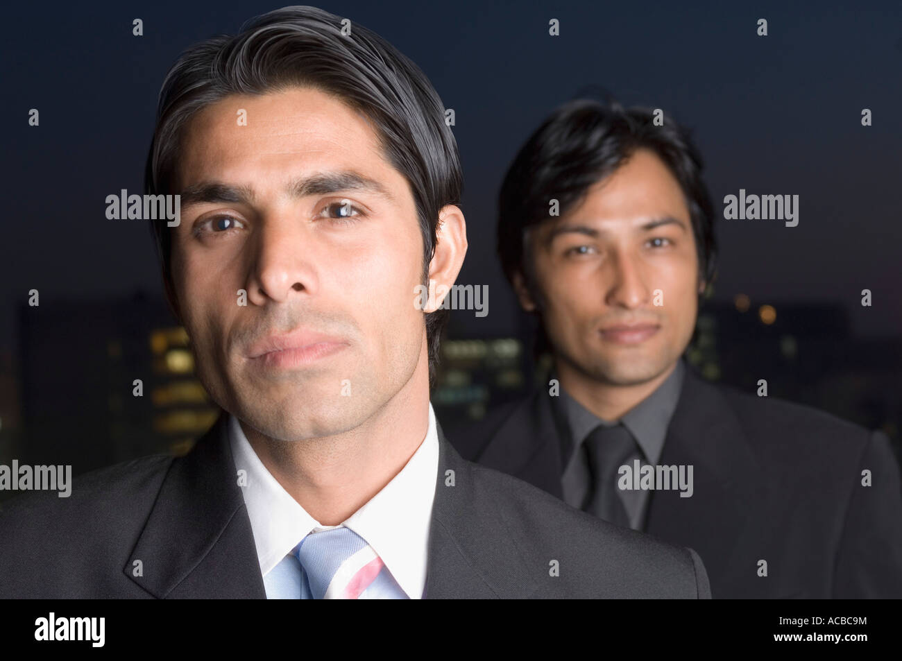 Portrait of two businessmen looking serious Stock Photo - Alamy