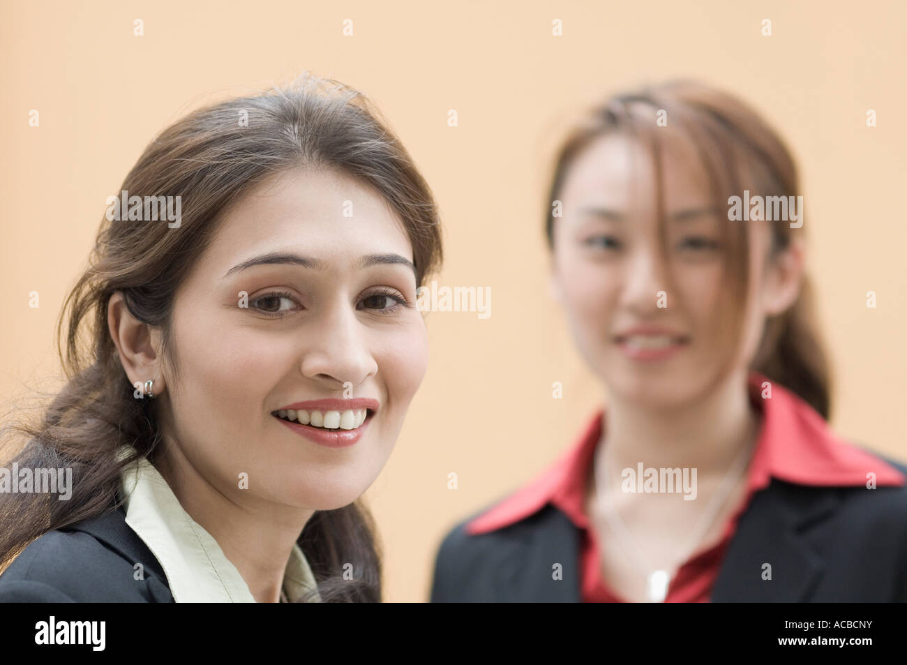 Portrait of two businesswomen smiling Stock Photo - Alamy