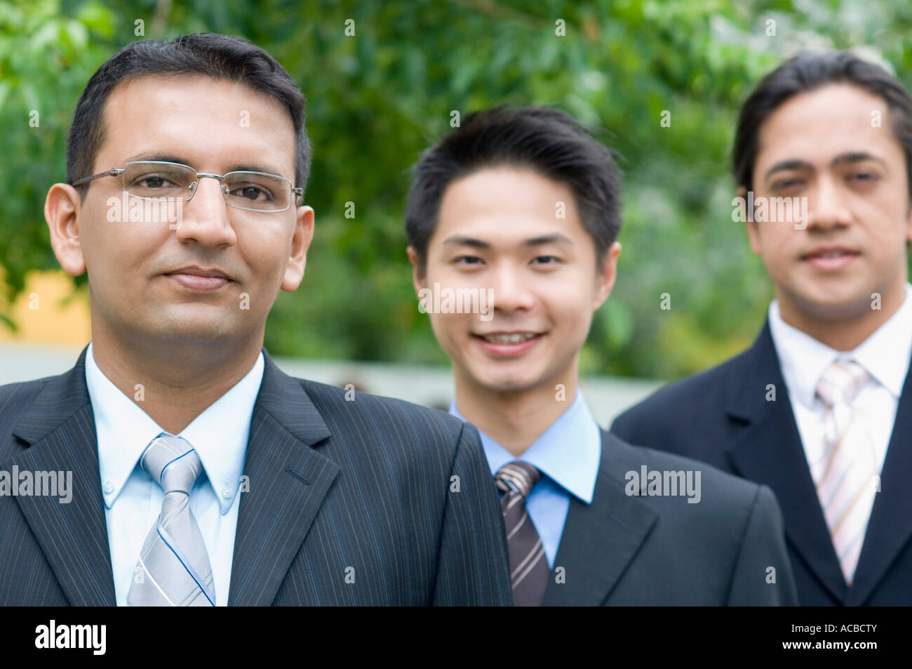 Portrait of three businessmen in a row Stock Photo - Alamy