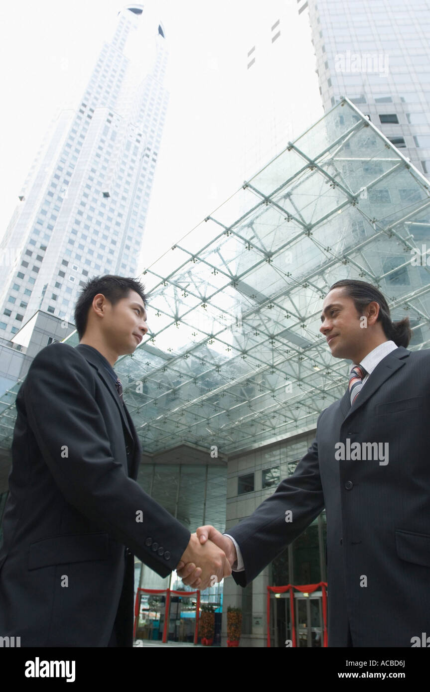 Side profile of two businessmen shaking hands Stock Photo - Alamy