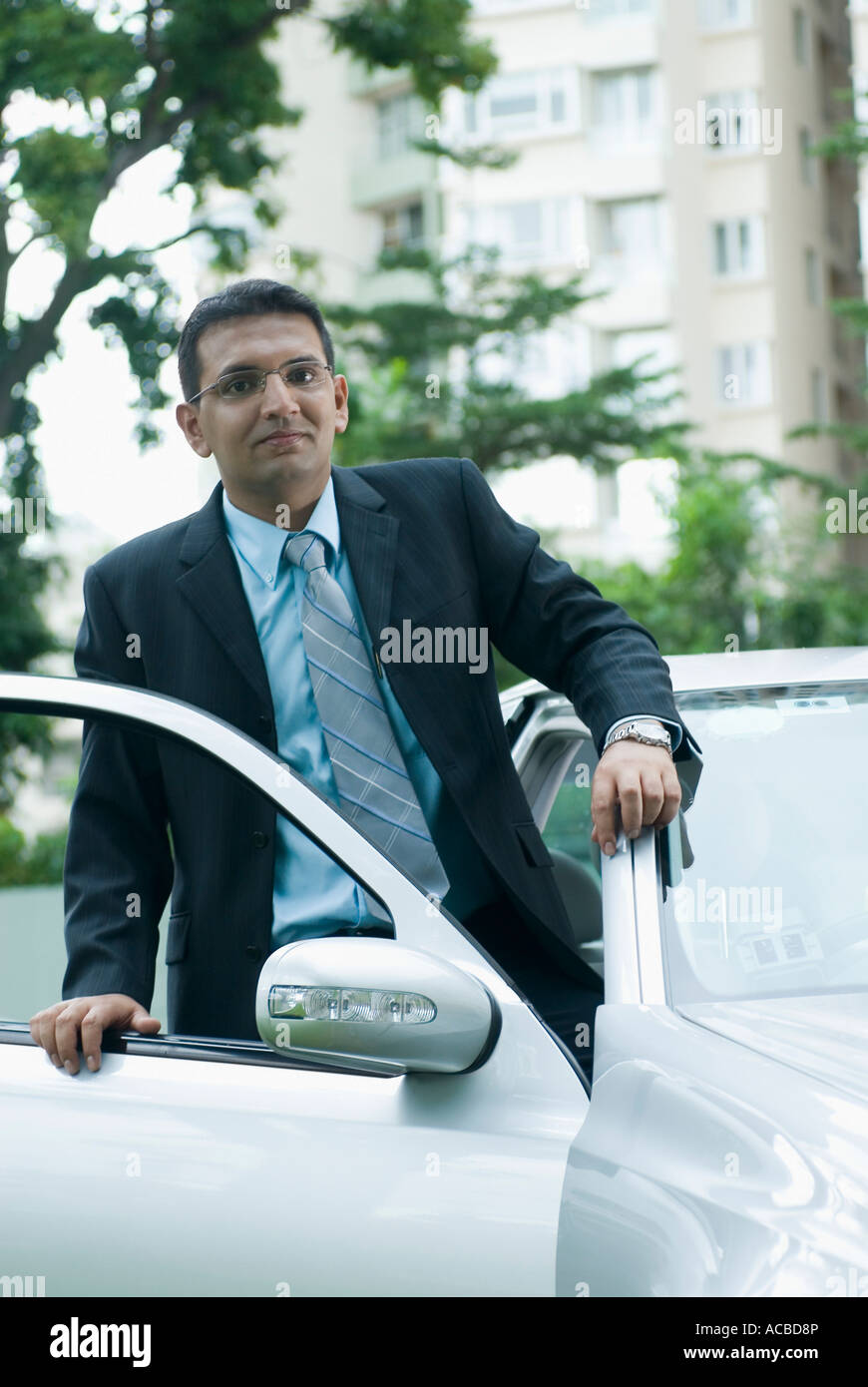 Portrait of a businessman getting into his car Stock Photo - Alamy