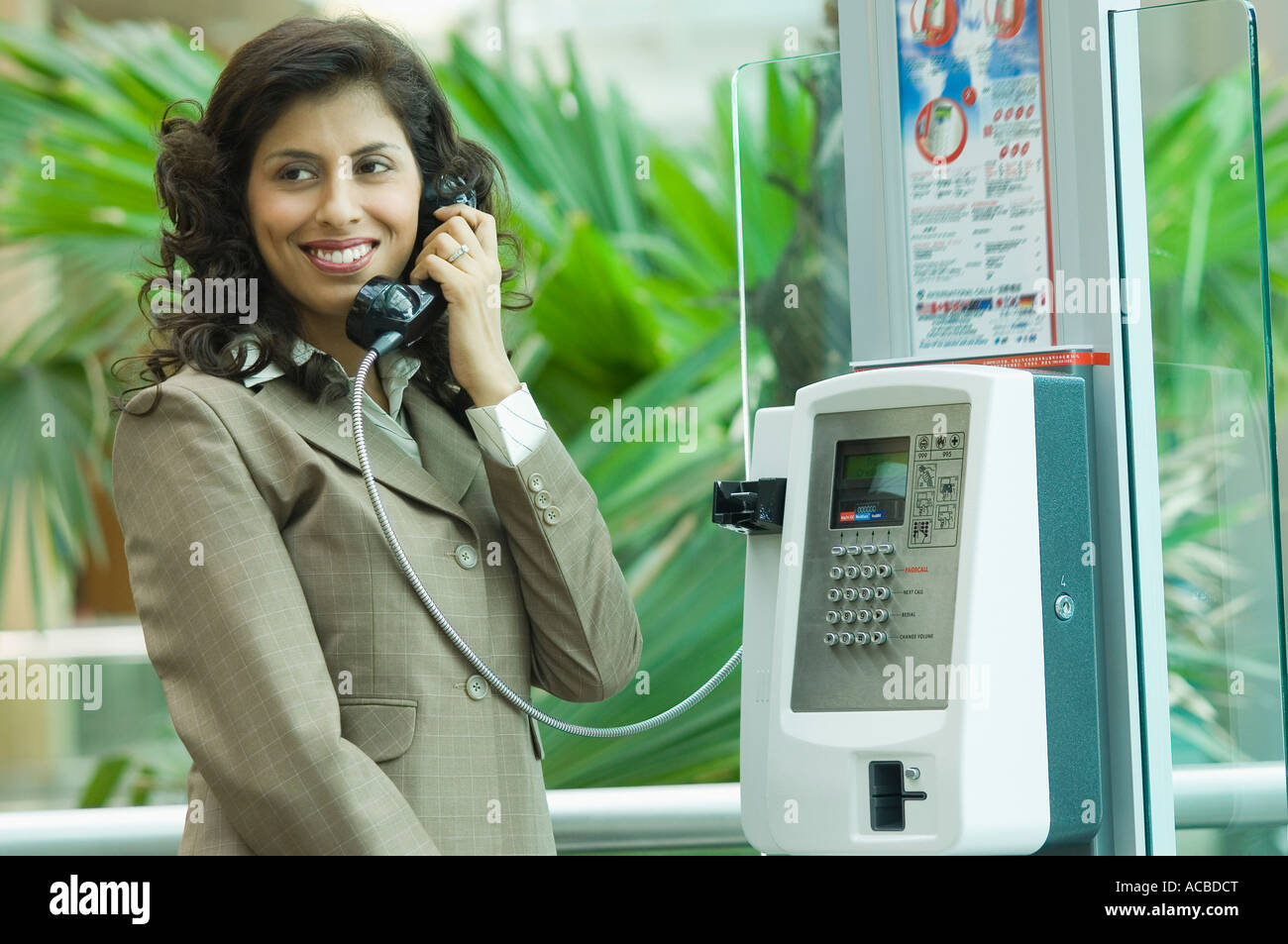 Close-up of a businesswoman talking on a pay phone Stock Photo - Alamy