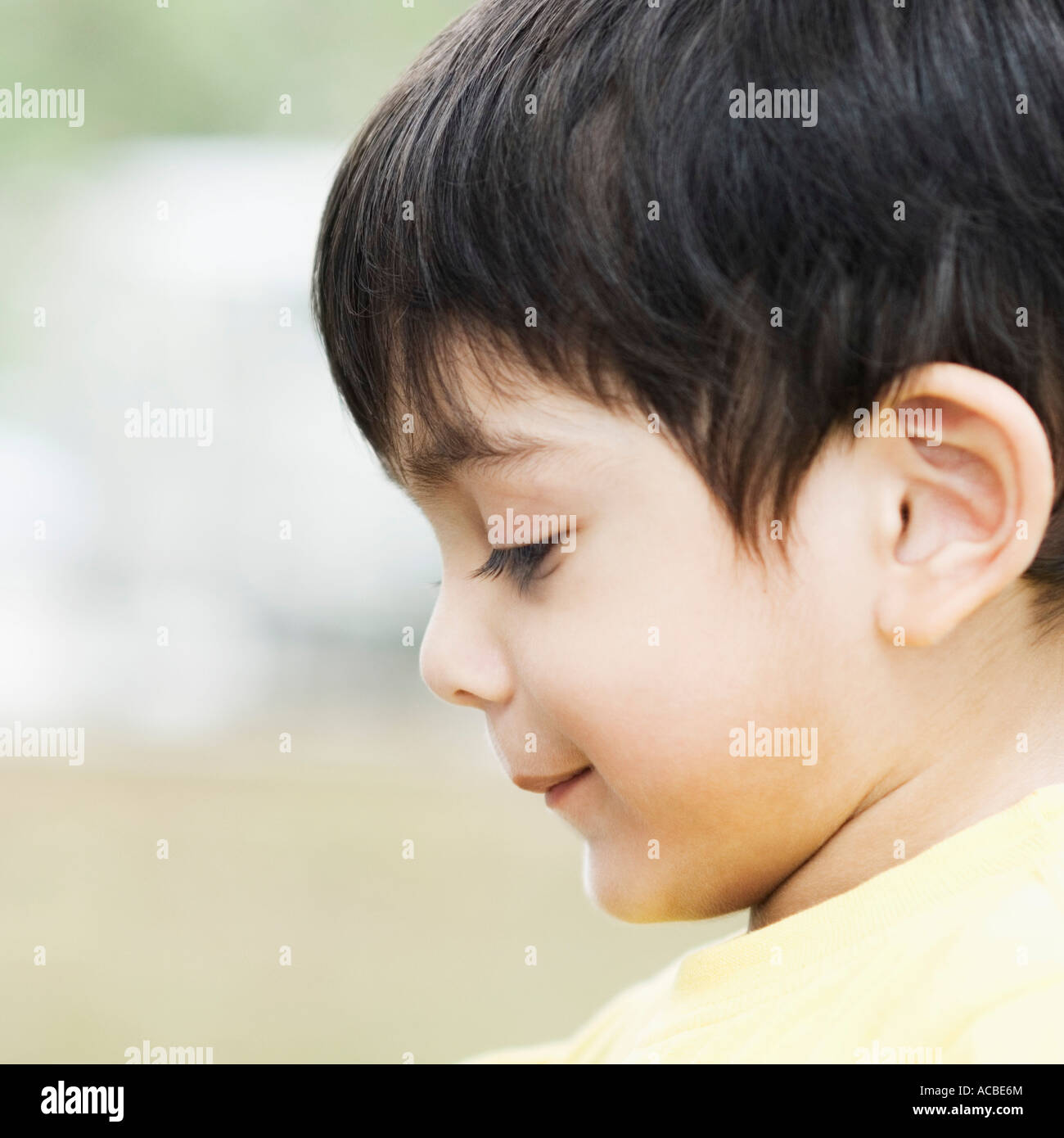 Side profile of a boy looking down Stock Photo - Alamy