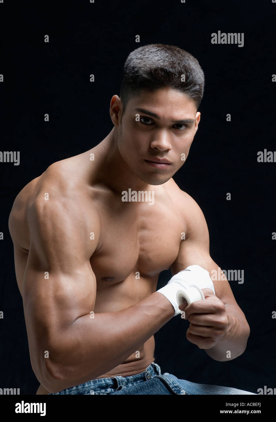 Portrait of a young man bandaging his hand Stock Photo - Alamy