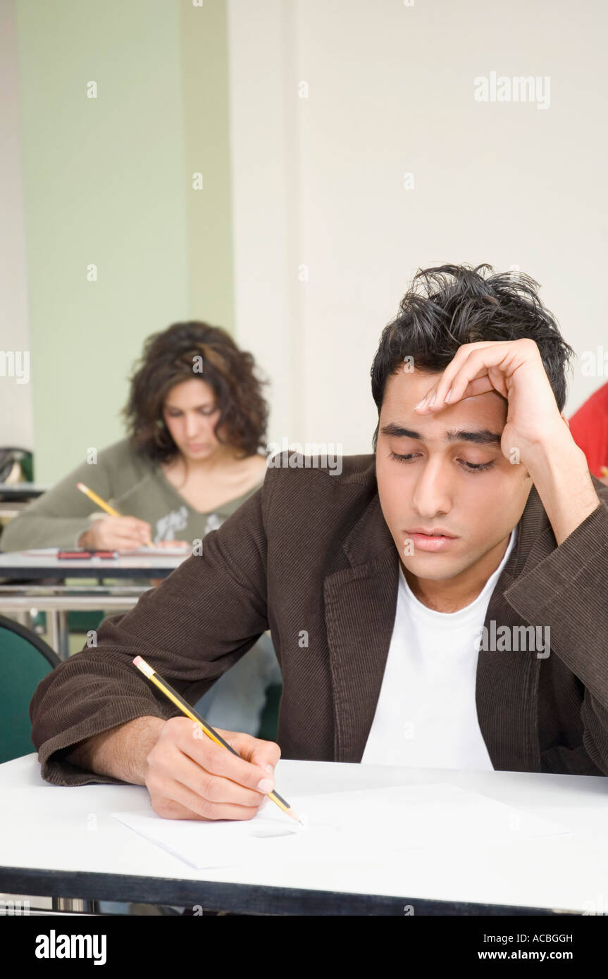Two college students giving an exam in a classroom Stock Photo - Alamy