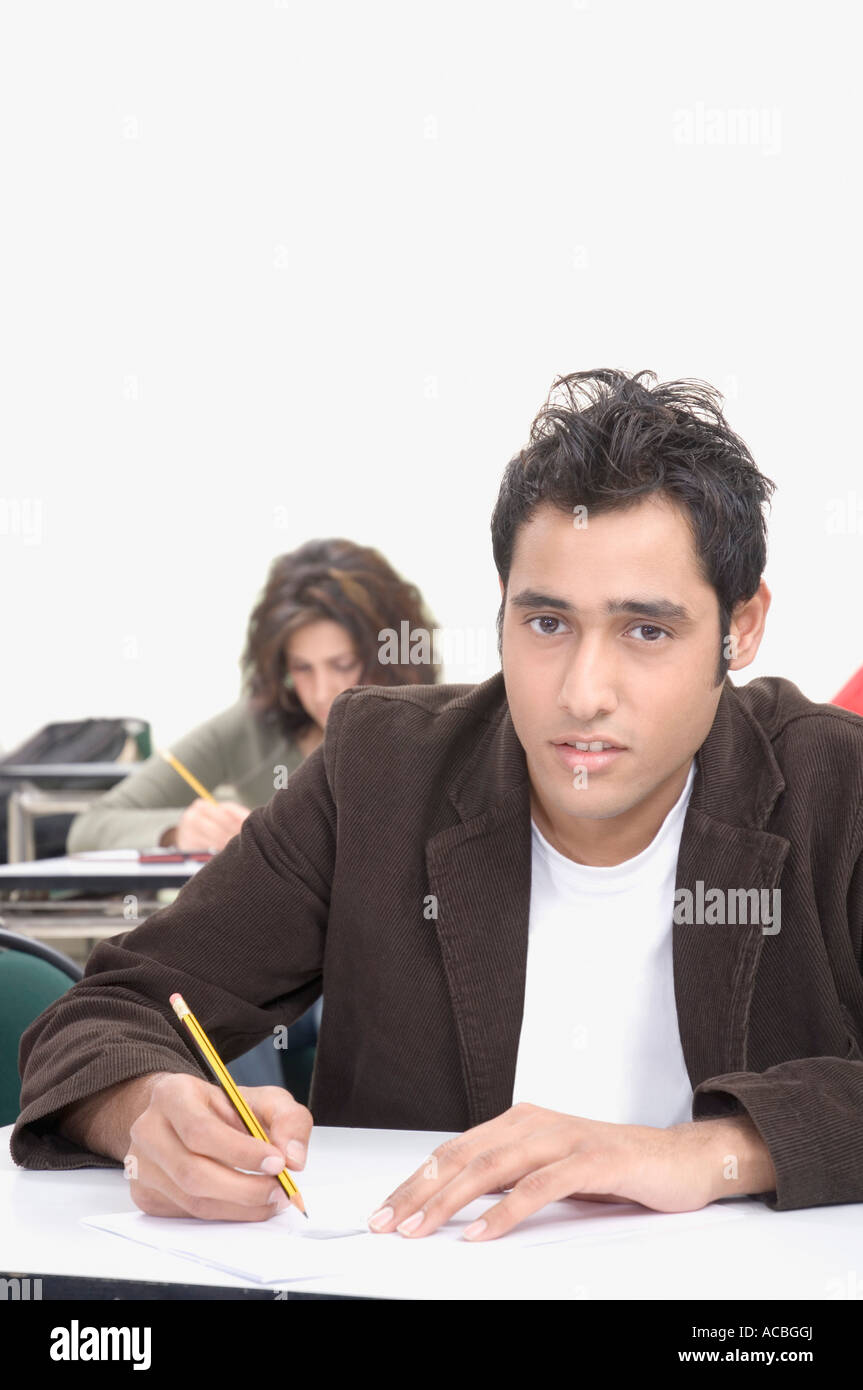 Portrait of a male college student giving an exam in a classroom Stock ...