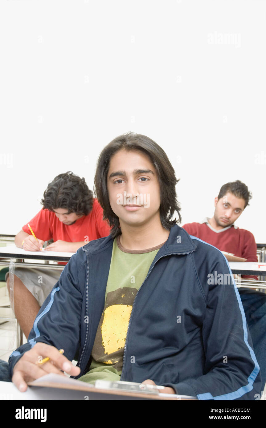 Portrait of a male college students giving an exam in a classroom Stock ...