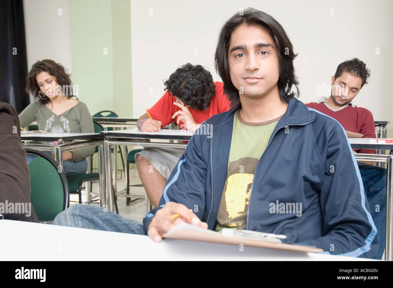 Portrait of a male college students giving an exam in a classroom Stock ...