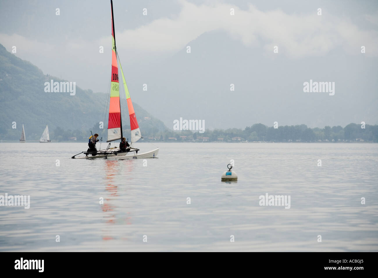 Small catamaran on the lake. Domaso, Lake Como, Italy Stock Photo - Alamy