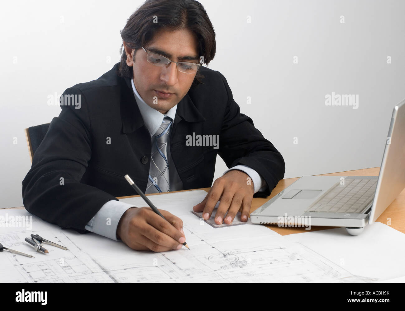 Architect drawing with a pencil on a blueprint Stock Photo - Alamy