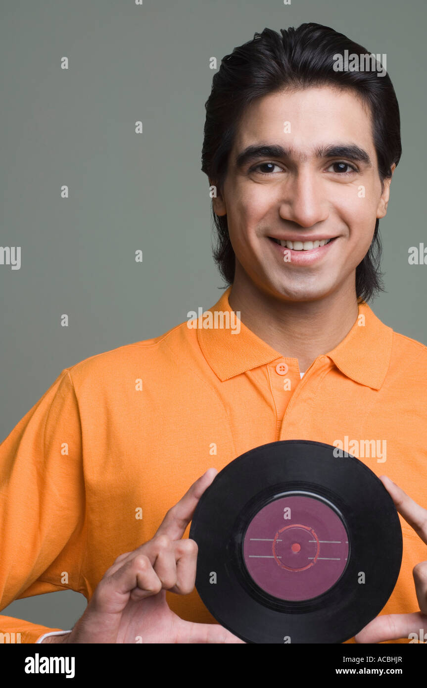 Portrait of a young man holding a record Stock Photo - Alamy