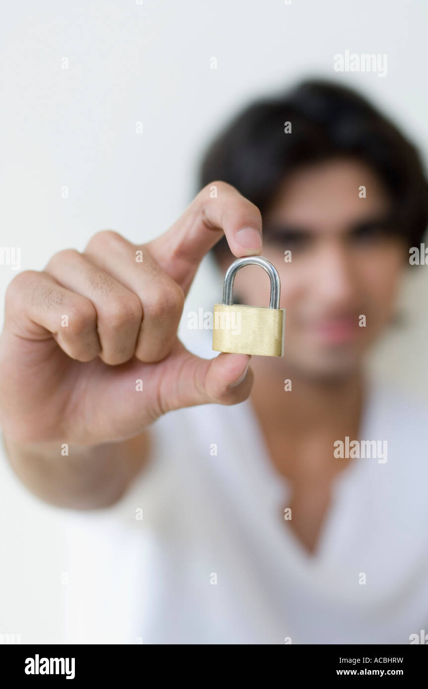 Young man holding a padlock Stock Photo - Alamy