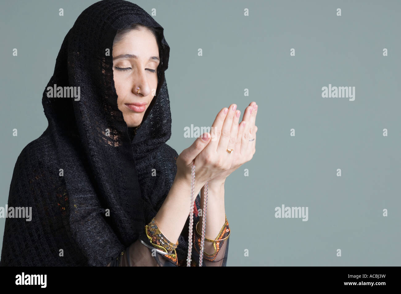 Close-up of a young woman praying Stock Photo - Alamy