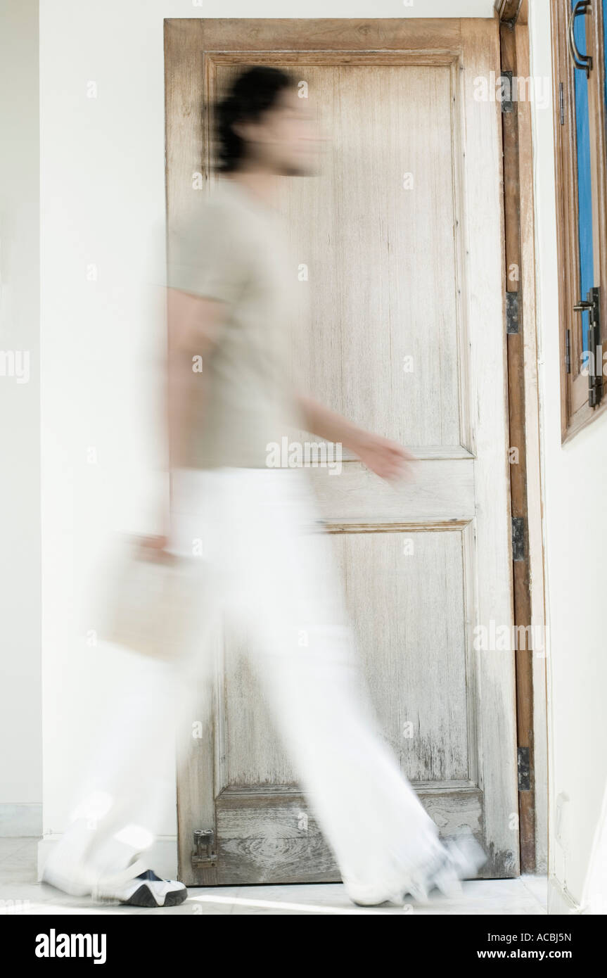 Side profile of a young man walking Stock Photo - Alamy