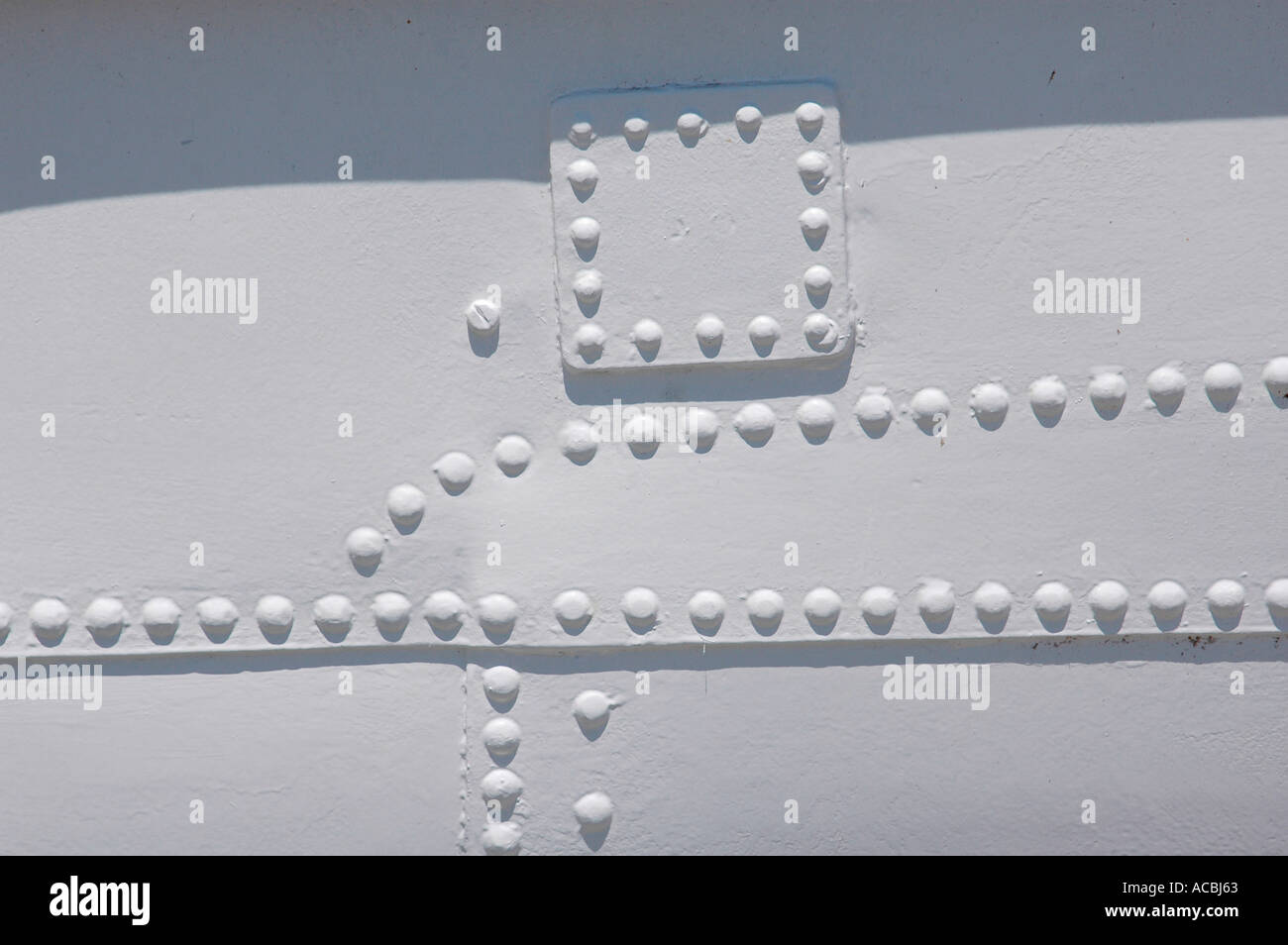 Rivets in the side of a white painted boat Stock Photo - Alamy