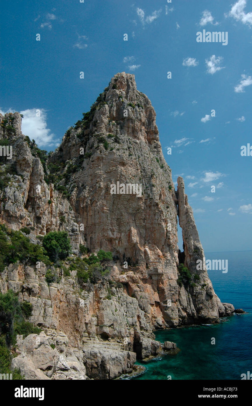 Limestone pillar and cliffs rising from the Mediternean Sea at Pedra ...