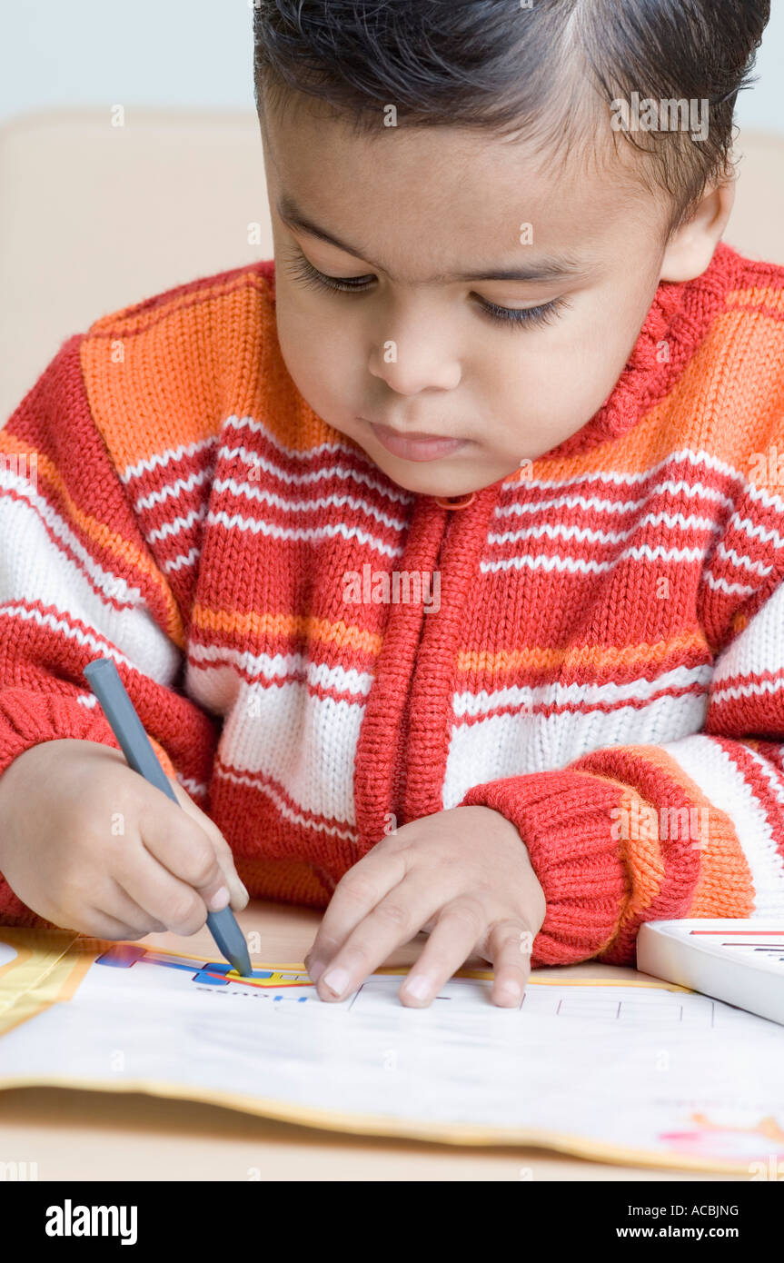 Close-up of a boy drawing with a crayon Stock Photo - Alamy