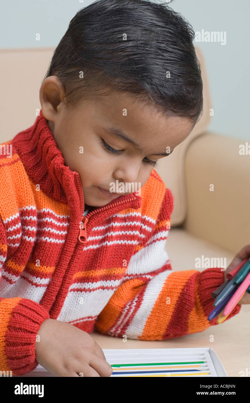Boy holding a crayon hi-res stock photography and images - Alamy