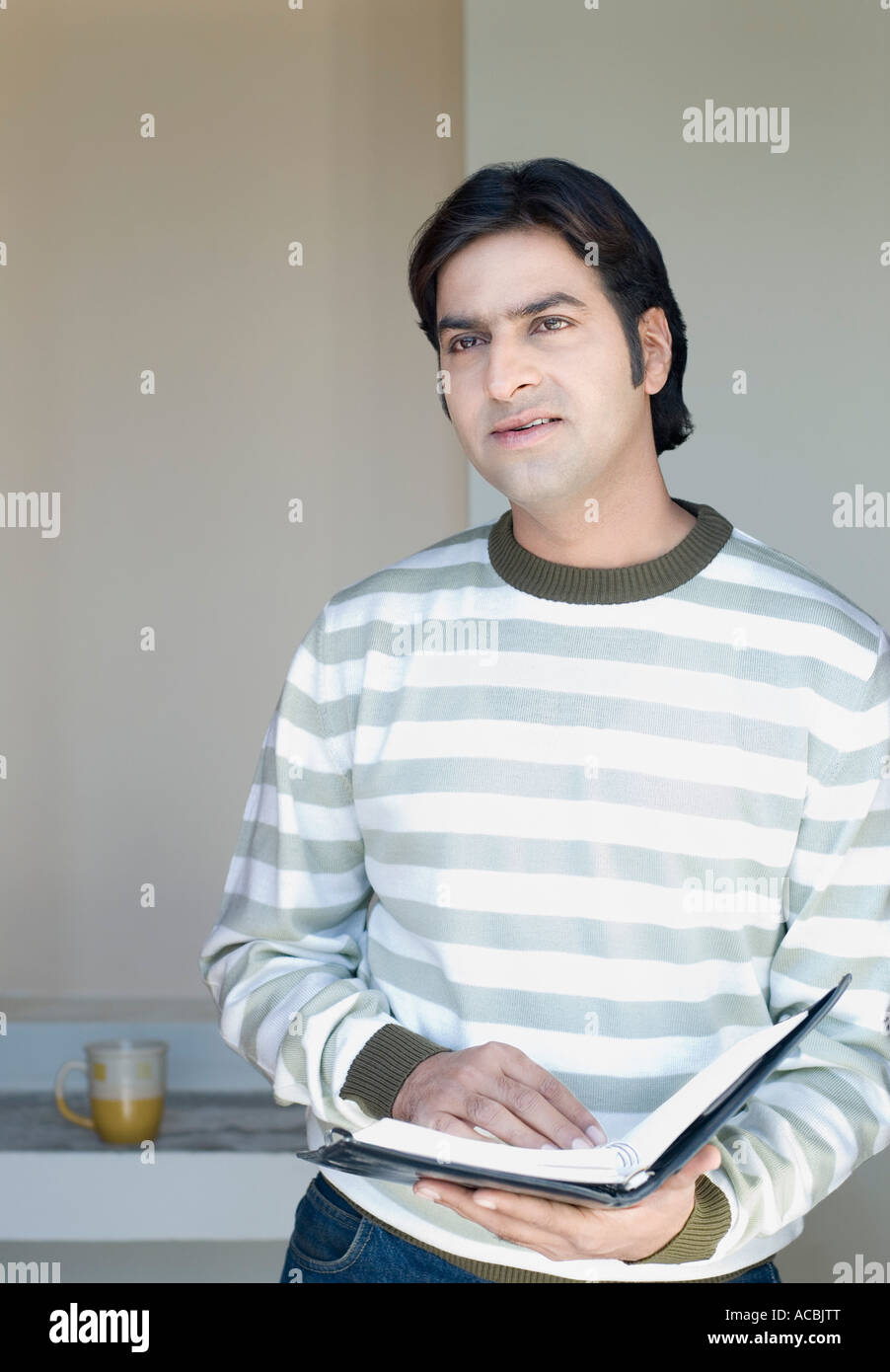 Mid adult man holding a diary Stock Photo - Alamy