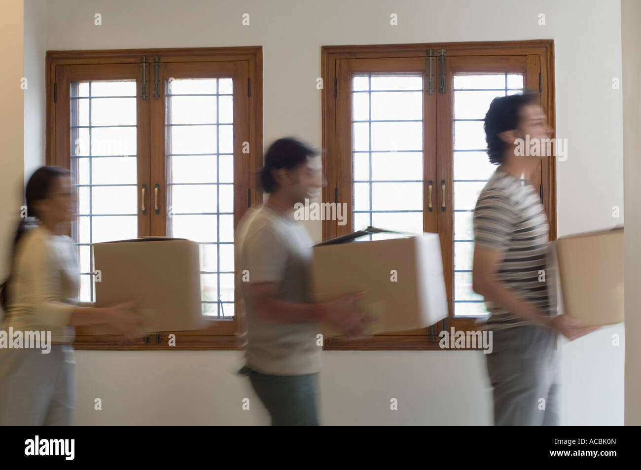 Side profile of two men and a woman carrying cardboard boxes Stock ...