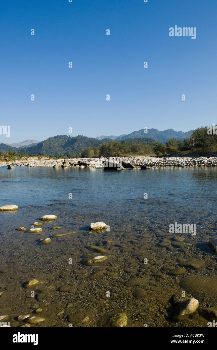 River flowing on rocks with mountains in the background, Jim Corbett ...