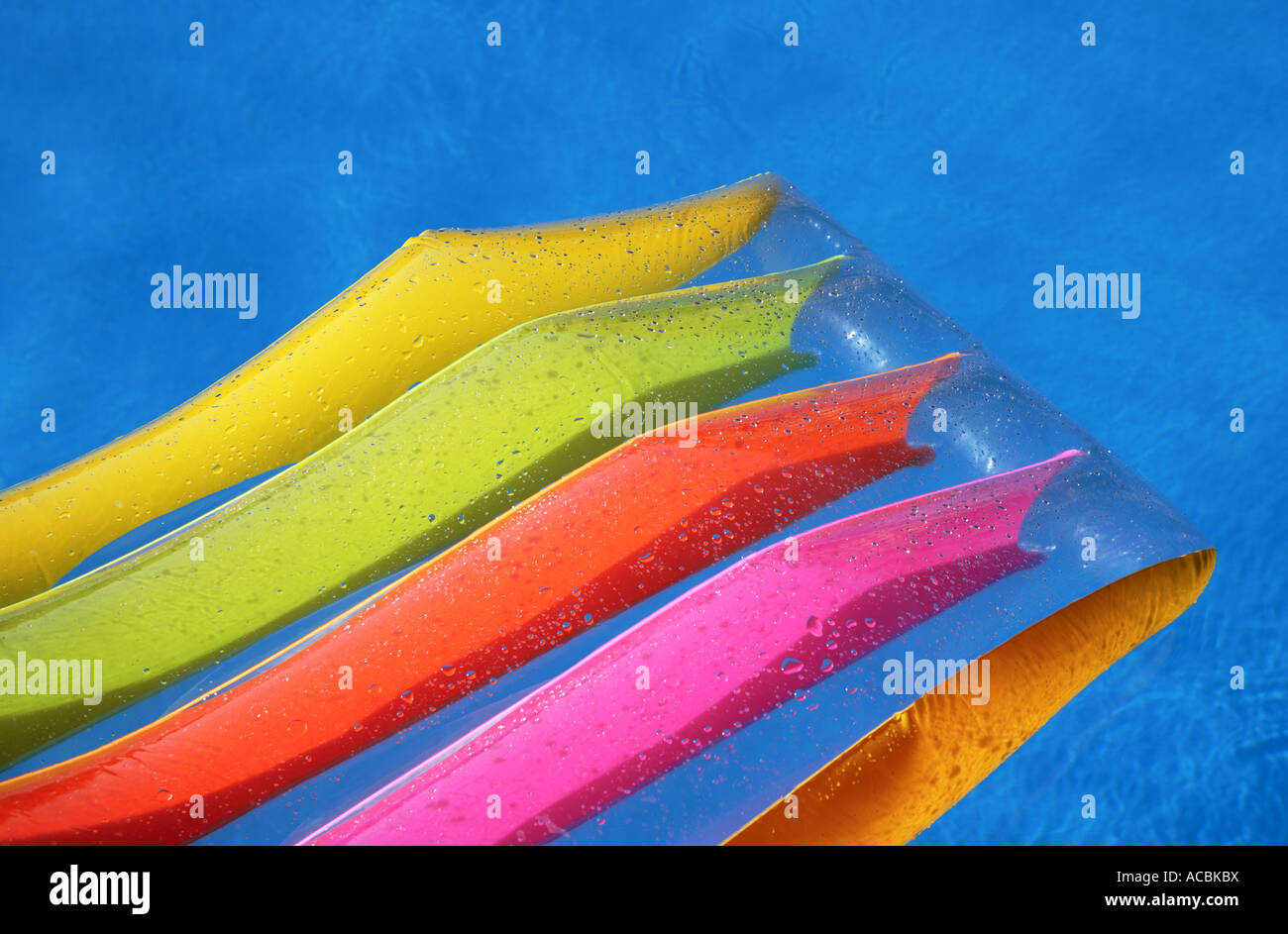 Colourful lilo in swimming pool Stock Photo - Alamy