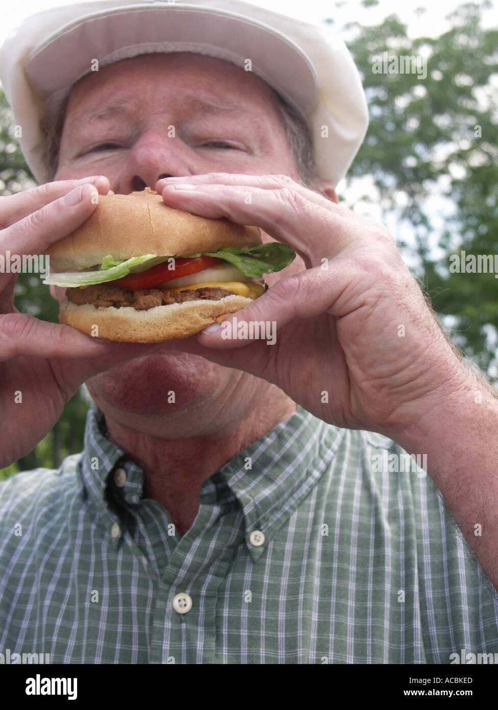 Big Bite of a Cheeseburger Stock Photo - Alamy