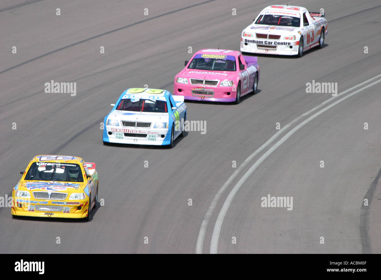 Racing pick up trucks racing around a banked circuit Stock Photo - Alamy