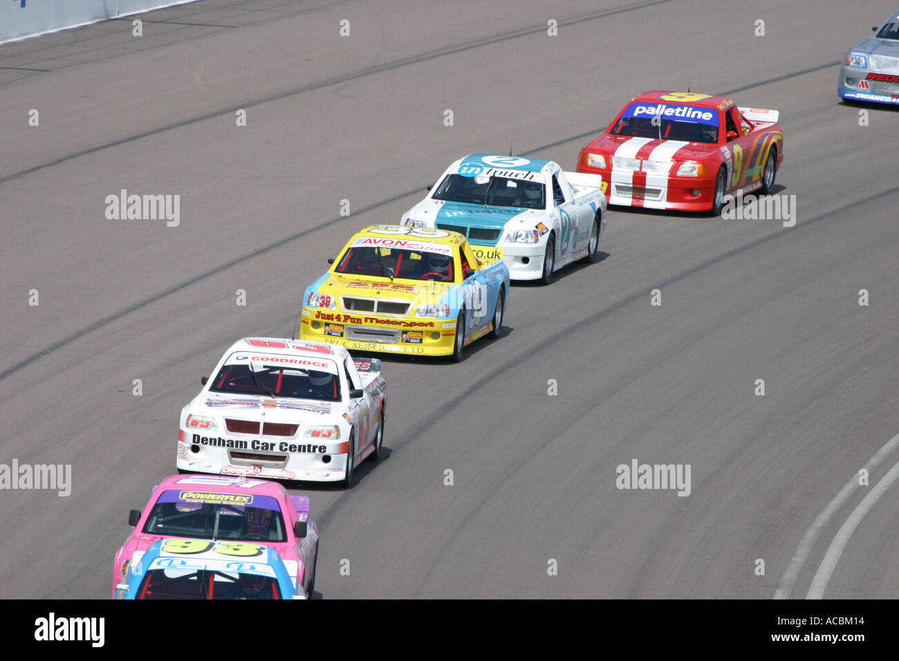 Racing pick up trucks racing around a banked circuit Stock Photo - Alamy
