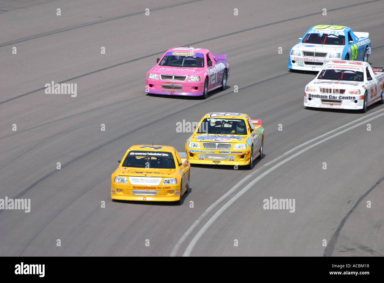 Racing pick up trucks racing around a banked circuit Stock Photo - Alamy