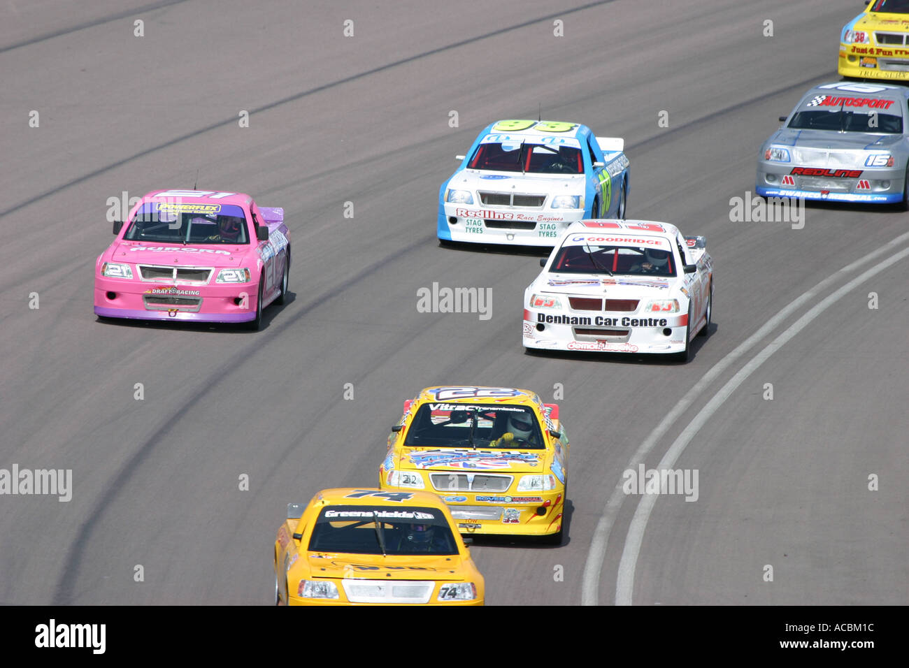 Racing pick up trucks racing around a banked circuit Stock Photo - Alamy