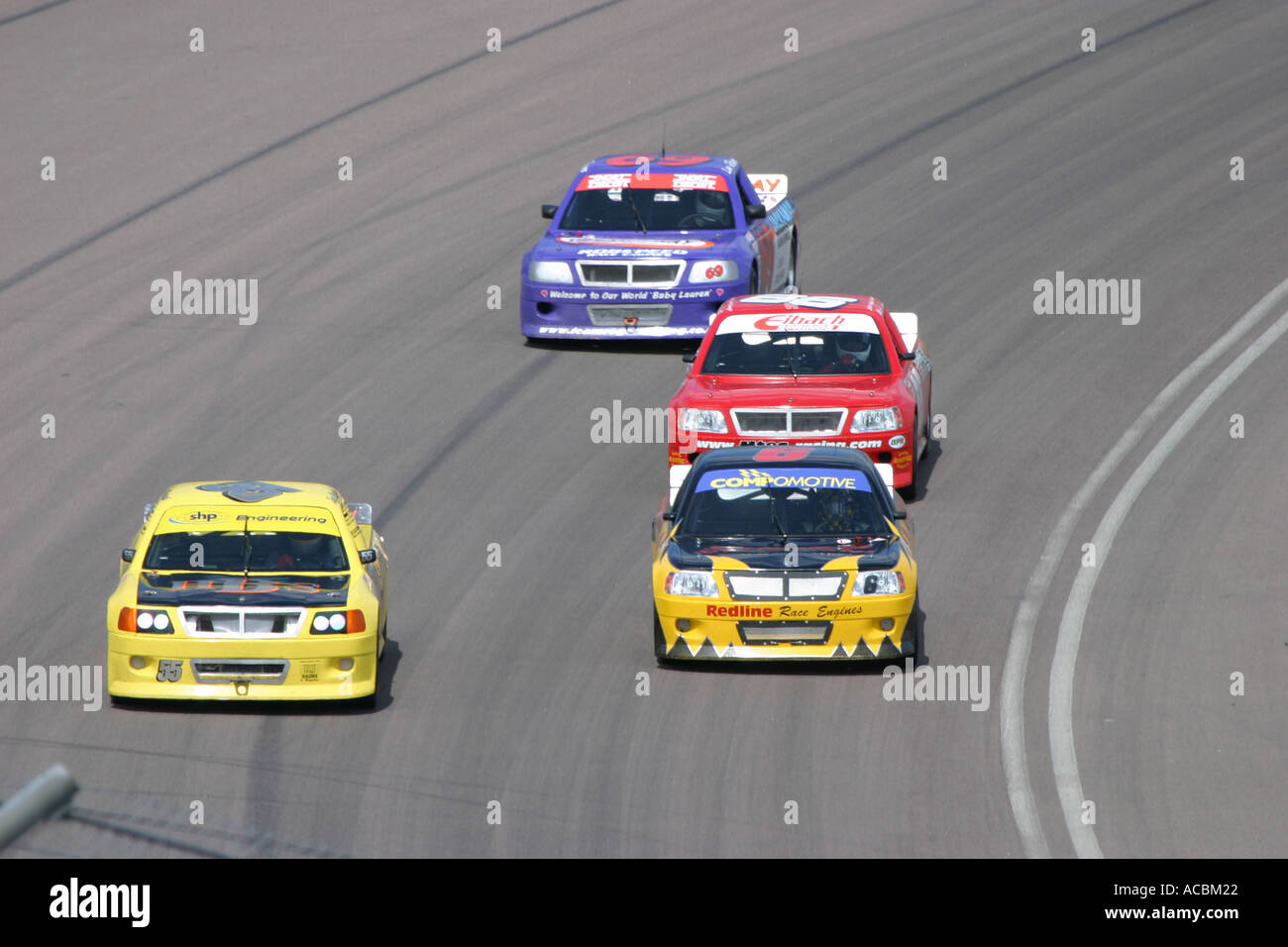 Racing pick up trucks racing around a banked circuit Stock Photo - Alamy