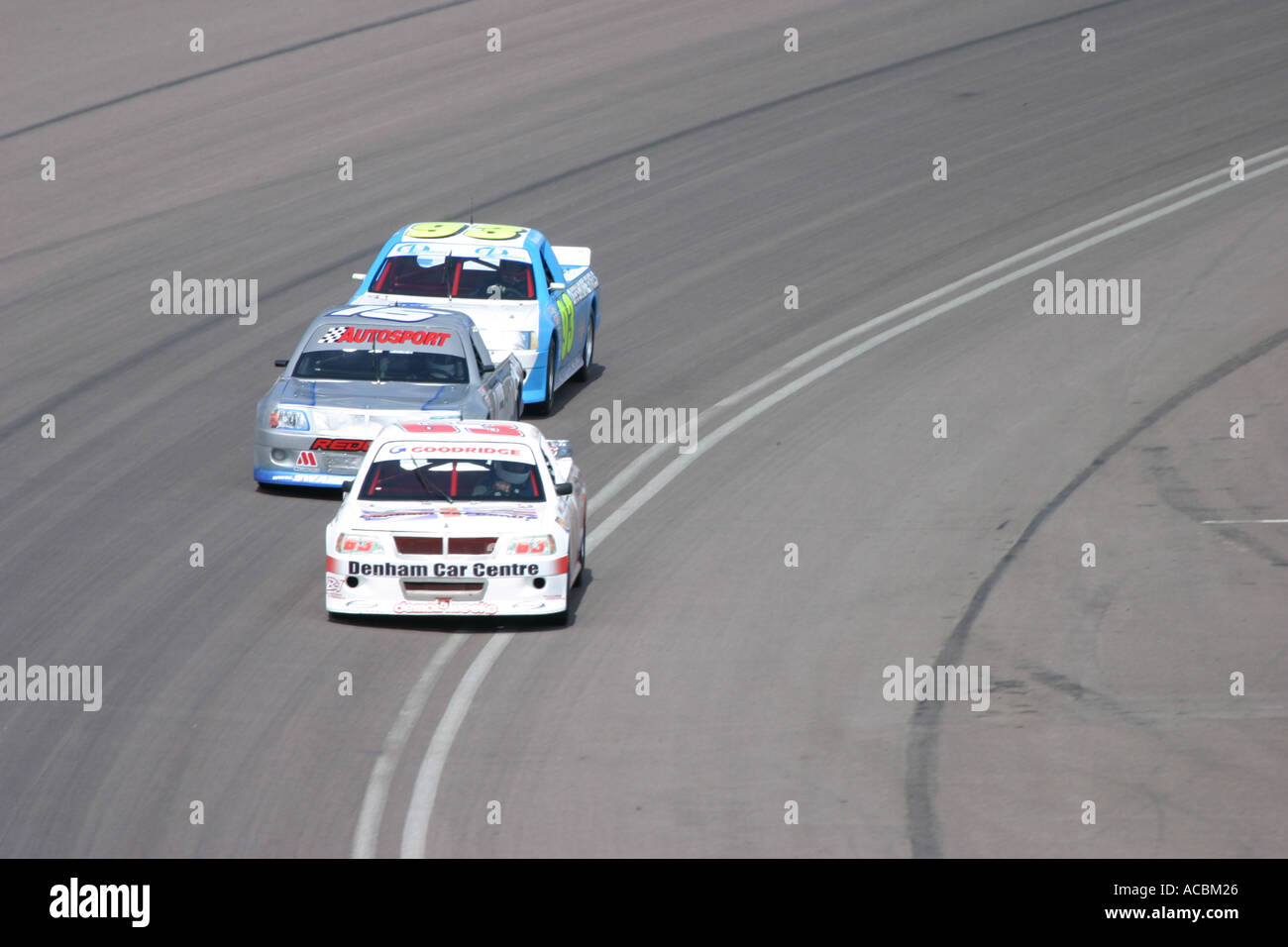 Racing pick up trucks racing around a banked circuit Stock Photo - Alamy