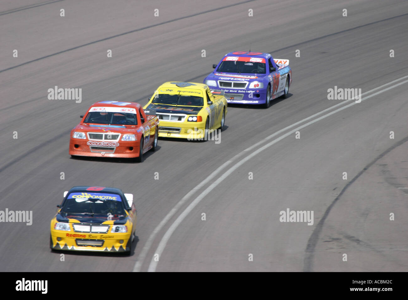 Racing pick up trucks racing around a banked circuit Stock Photo - Alamy