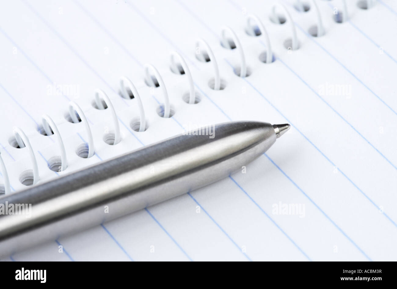 Pen on notebook Stock Photo - Alamy