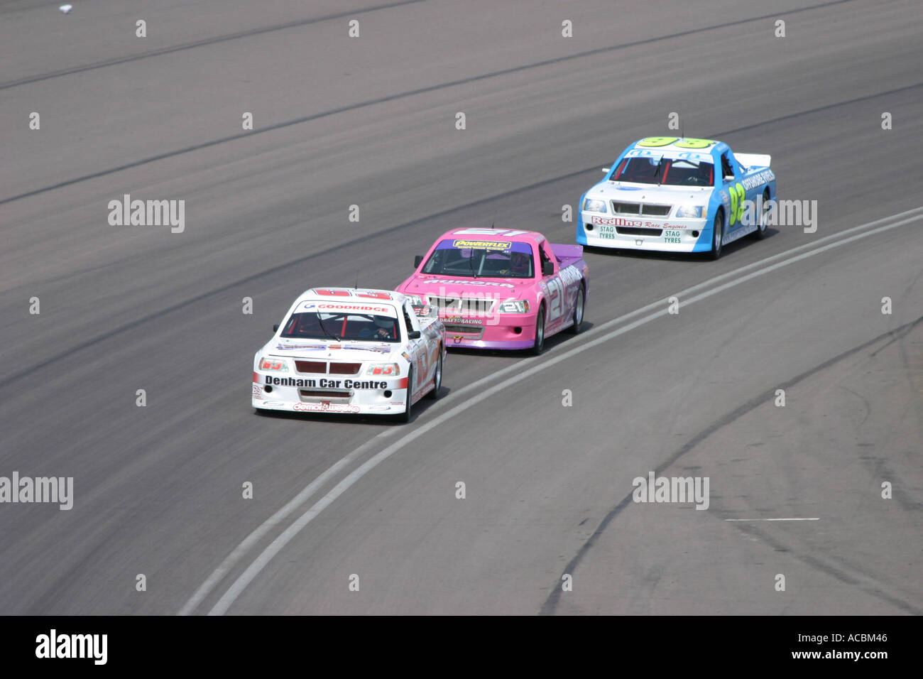 Racing pick up trucks racing around a banked circuit Stock Photo - Alamy