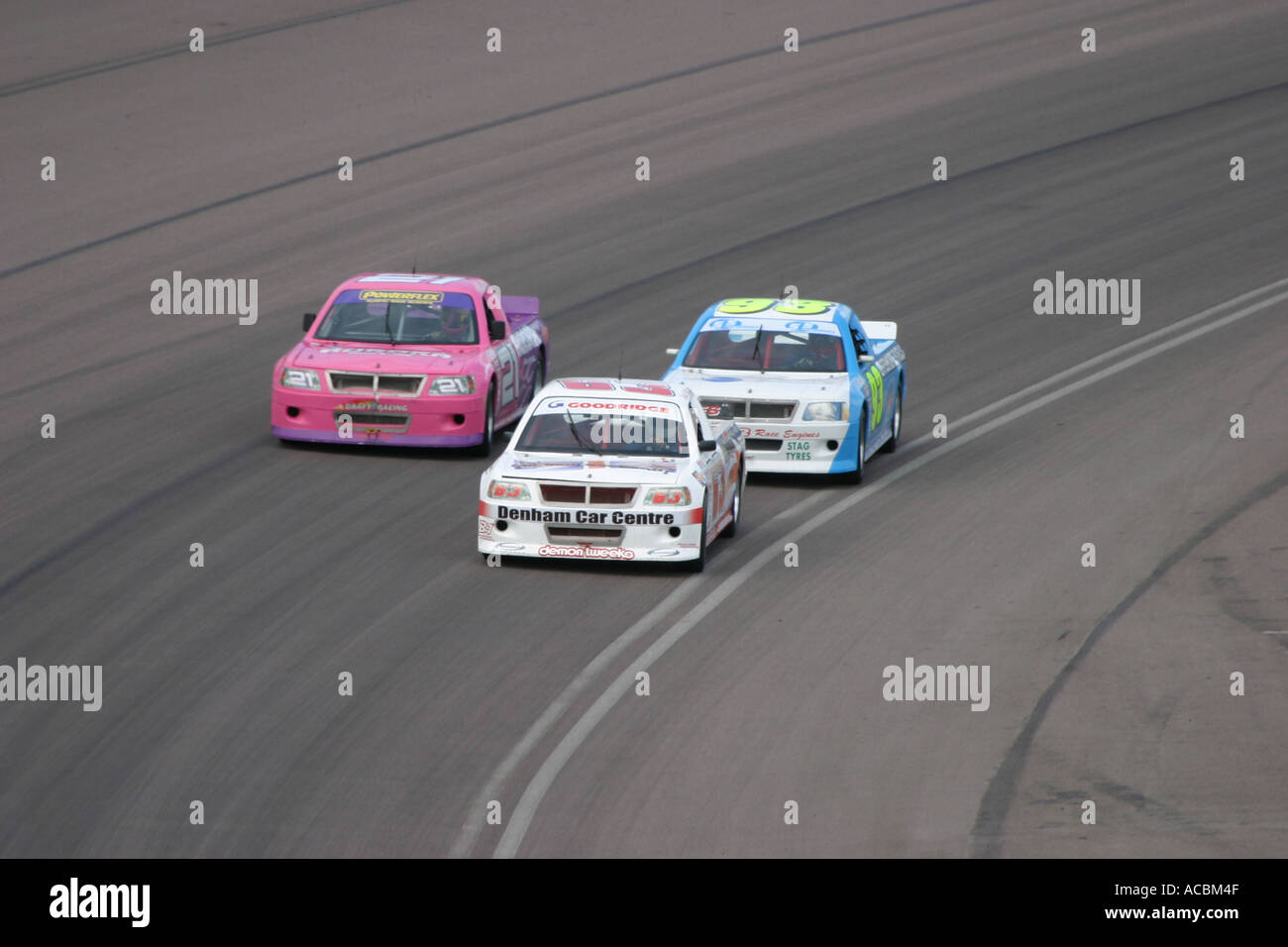 Racing pick up trucks racing around a banked circuit Stock Photo - Alamy
