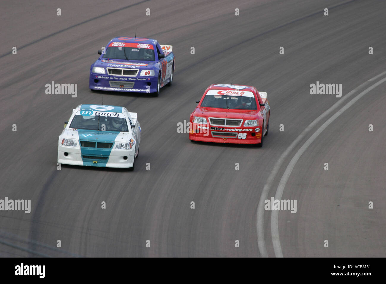Racing pick up trucks racing around a banked circuit Stock Photo - Alamy