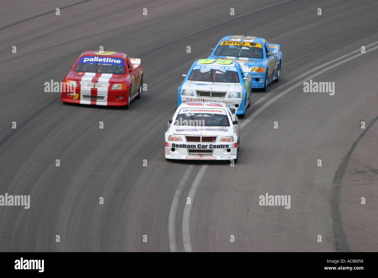 Racing pick up trucks racing around a banked circuit Stock Photo - Alamy