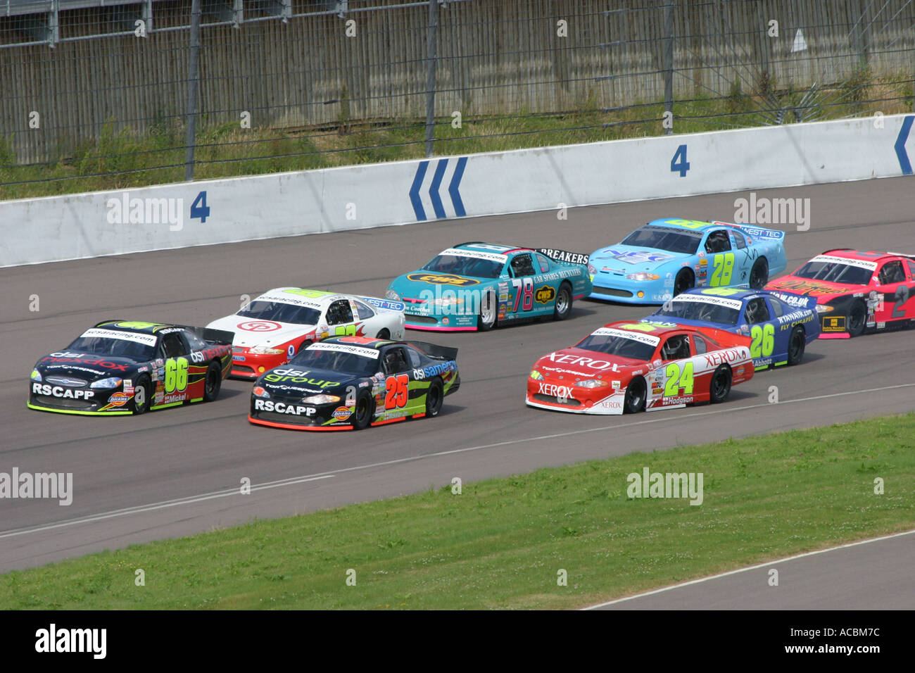 V8 Nascar type stock cars racing on a banked oval circuit Stock Photo ...