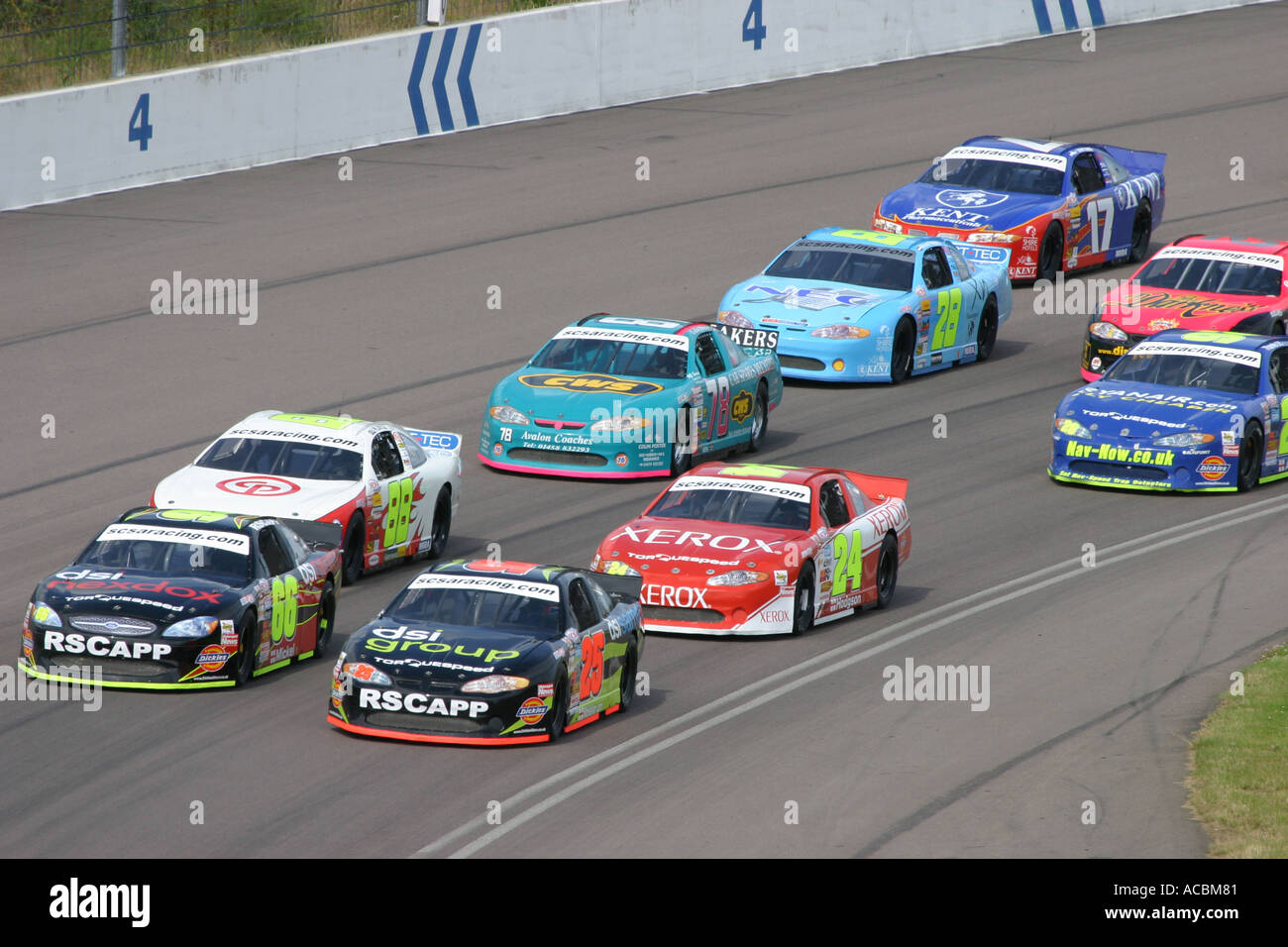 V8 Nascar type stock cars racing on a banked oval circuit Stock Photo ...