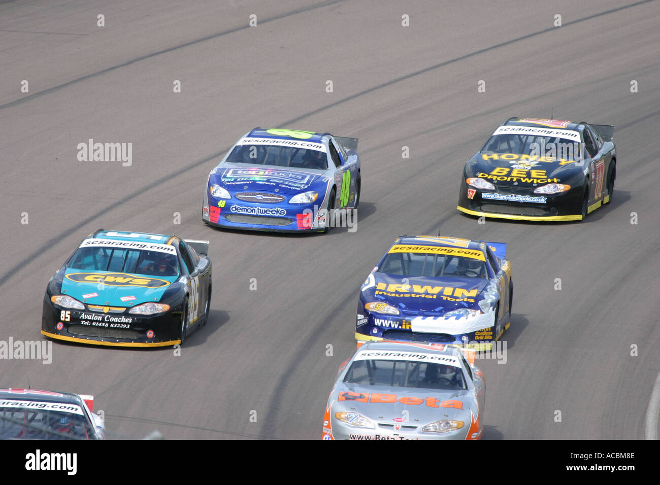 V8 Nascar type stock cars racing on a banked oval circuit Stock Photo ...