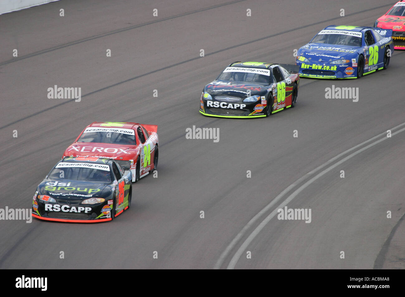V8 Nascar type stock cars racing on a banked oval circuit Stock Photo ...